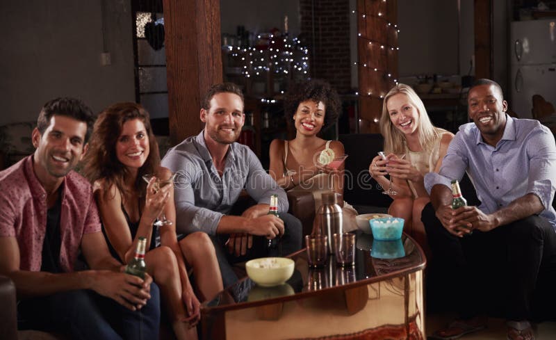 Group of Friends at a House Party Sit Looking To Camera Stock Photo ...