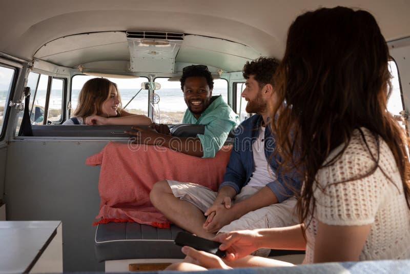 Group of Friends Interacting with Each Others in Camper Van at Beach ...