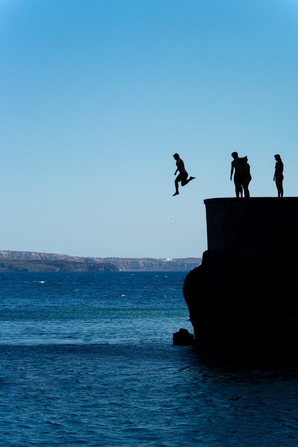 Group of Friends Jumping into Mediterranean Sea from Rock Cliff Stock ...