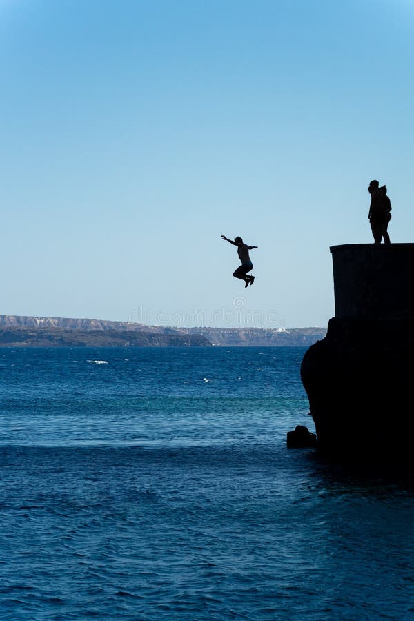 Group of Friends Jumping into Mediterranean Sea from Rock Cliff Stock ...