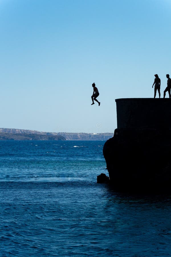 Group of Friends Jumping into Mediterranean Sea from Rock Cliff Stock ...