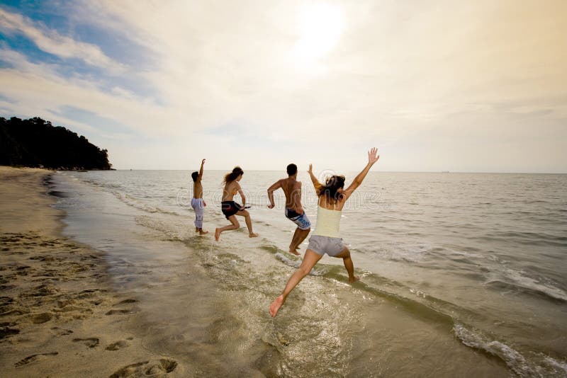 Group of Friends Jumping into the Sea Stock Photo - Image of attractive ...