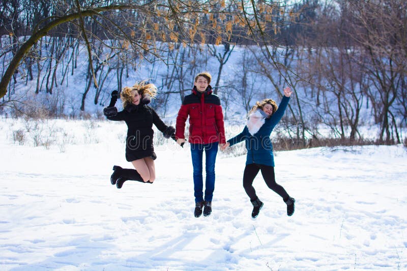 Group of Friends Jumping Together in the Park in Winter Stock Image ...