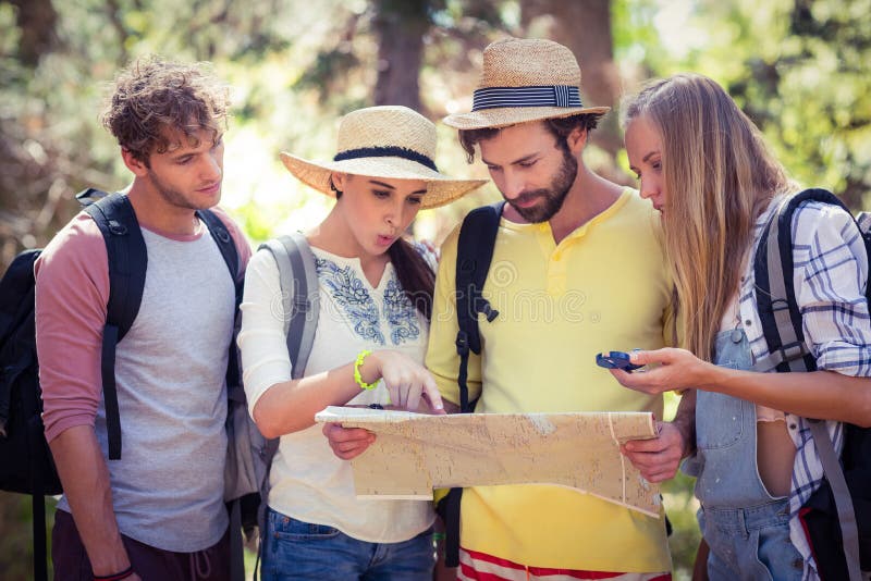 Group of Friends Looking at Map Stock Image - Image of holding, compass ...