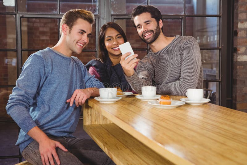 Group of Friends Looking at Their Smartphone Stock Image - Image of ...