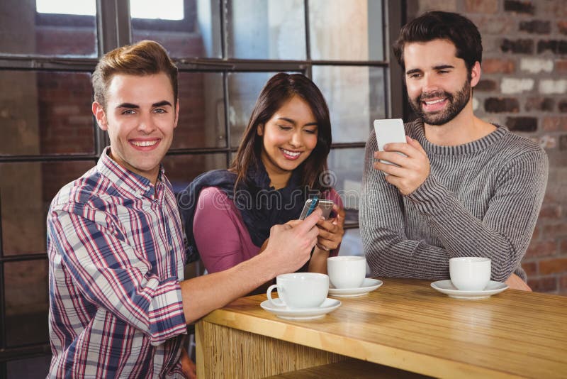 Group of Friends Looking at Their Smartphone Stock Image - Image of ...