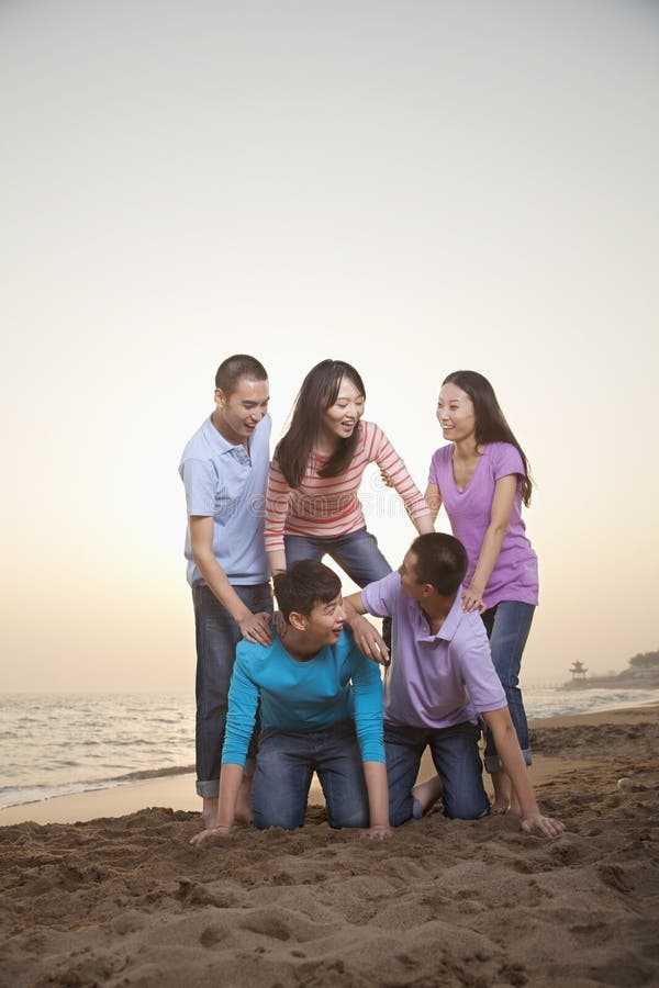 Group of Friends Making Human Pyramid on the Beach Stock Image - Image ...