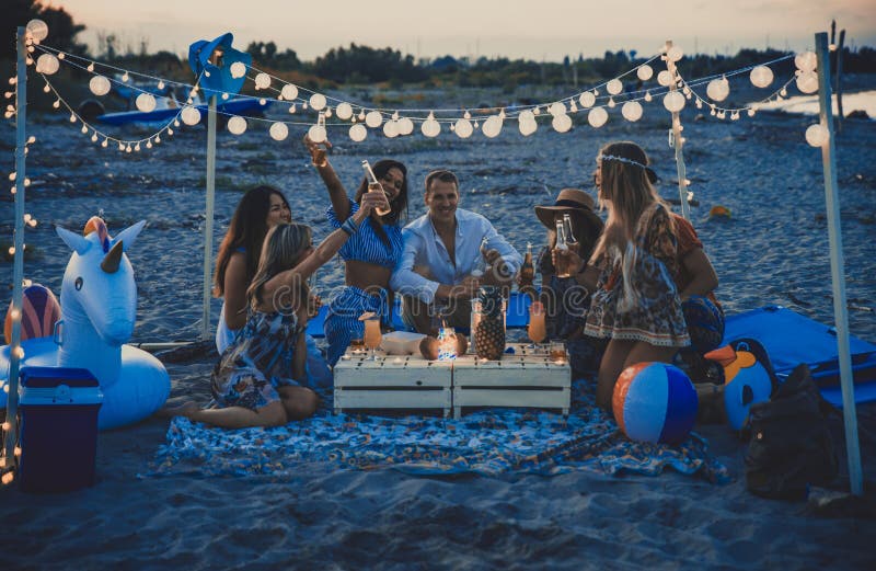 Group of Friends Making Party on the Beach at Sunset Time Stock Image ...
