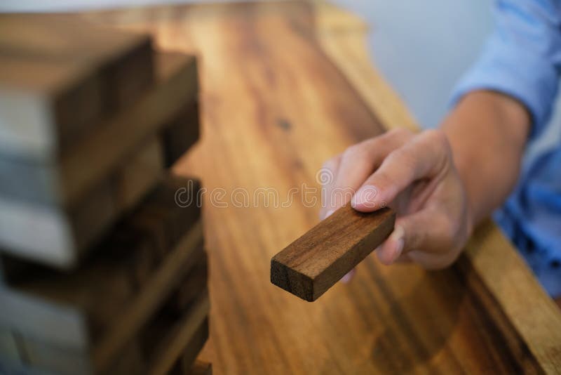 Group of Friends Playing Blocks Wood Game on the Table Folded Pu Stock ...