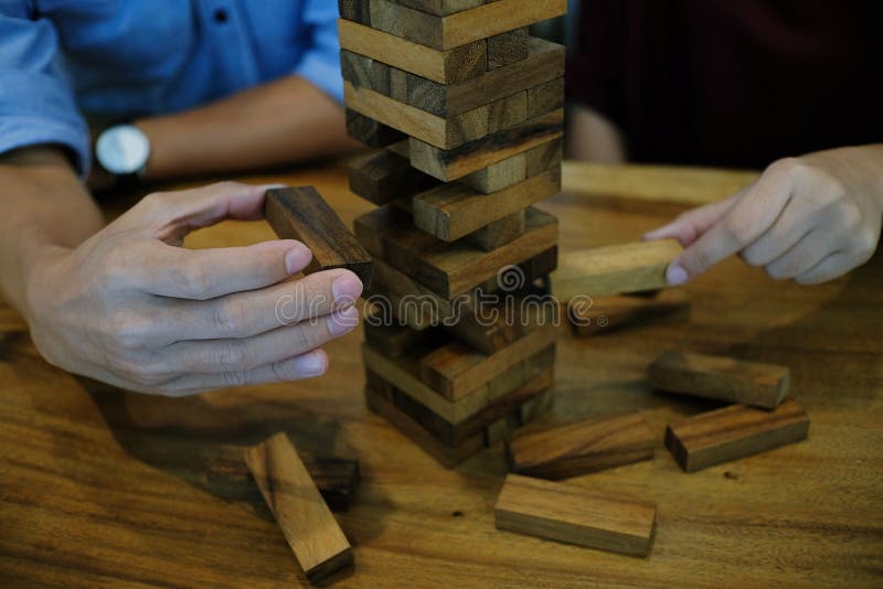Group of Friends Playing Blocks Wood Game on the Table Folded Pu Stock ...