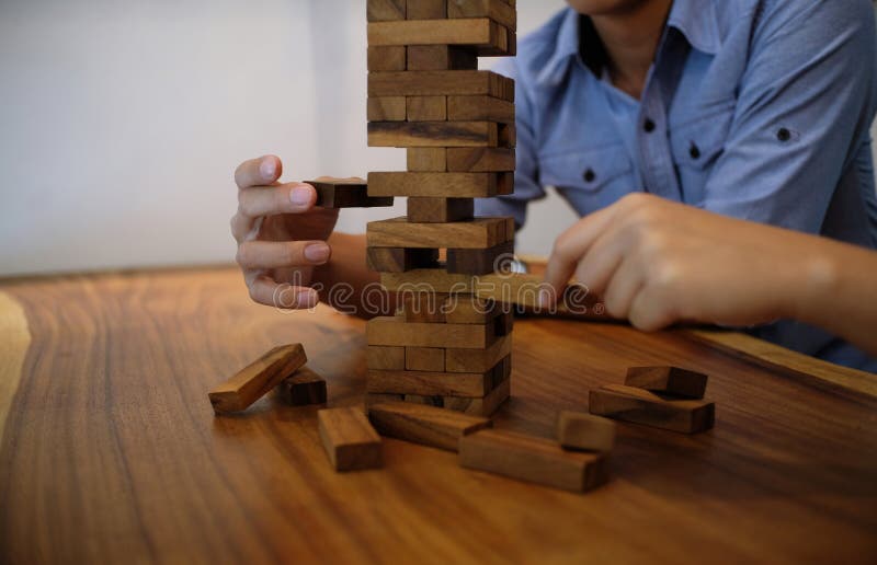 Group of Friends Playing Blocks Wood Game on the Table Folded Pu Stock ...