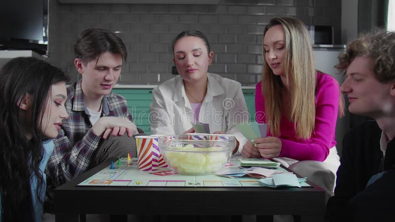 A Group of Friends Playing a Board Game with Cards and Dice. Stock ...