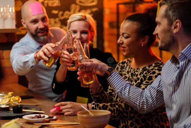 Group of Friends Playing Sticky Head Game Behind Bar Counter in a Cafe ...
