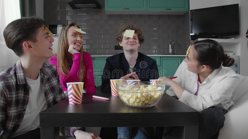 Group of Friends Playing Who am I Game with Sticky Papers. Name Game ...