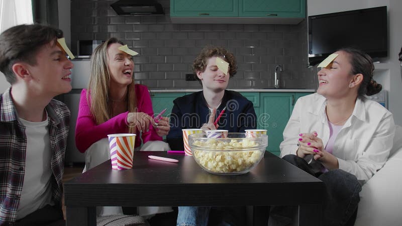 Group of Friends Playing Who am I Game with Sticky Papers. Name Game ...