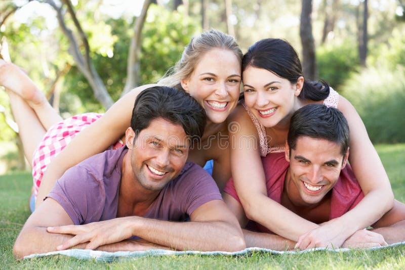 Group of Friends Relaxing in Park Together Stock Image - Image of ...