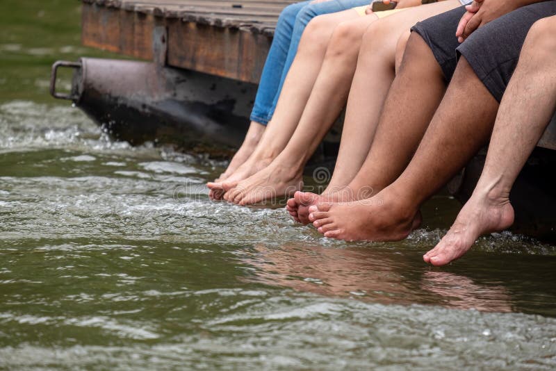 Group of Friends Relaxing on the Wooden Float Above the River Stock ...