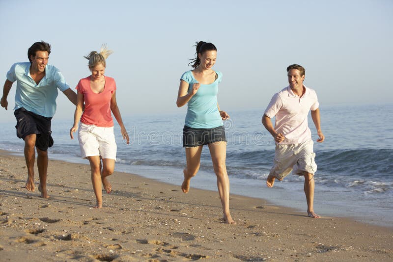 Group of Friends Running Along Beach Stock Image - Image of friendship ...