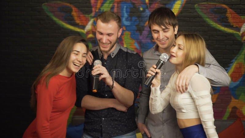 Group of Friends Singing Karaoke in a Nightclub. Slow Motion. Stock ...