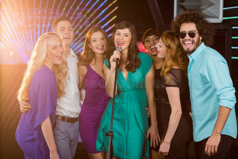 Group of Friends Singing Song Together in Bar Stock Image - Image of ...