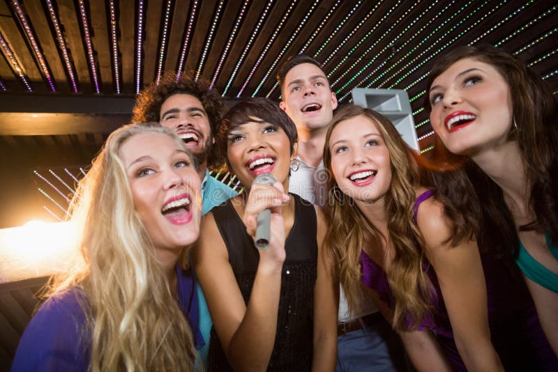 Group of Friends Singing Song Together in Bar Stock Image - Image of ...