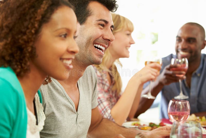 Group of Friends Sitting Around Table Having Dinner Party Stock Photo ...