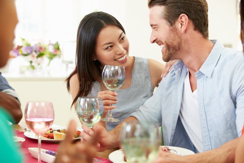 Group of Friends Sitting Around Table Having Dinner Party Stock Photo ...