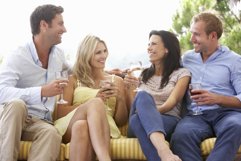 Group of Friends Sitting on Outdoor Seat Together Stock Image - Image ...