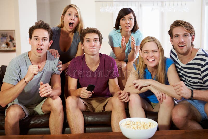 Group of Friends Sitting on Sofa Watching TV Together Stock Image ...