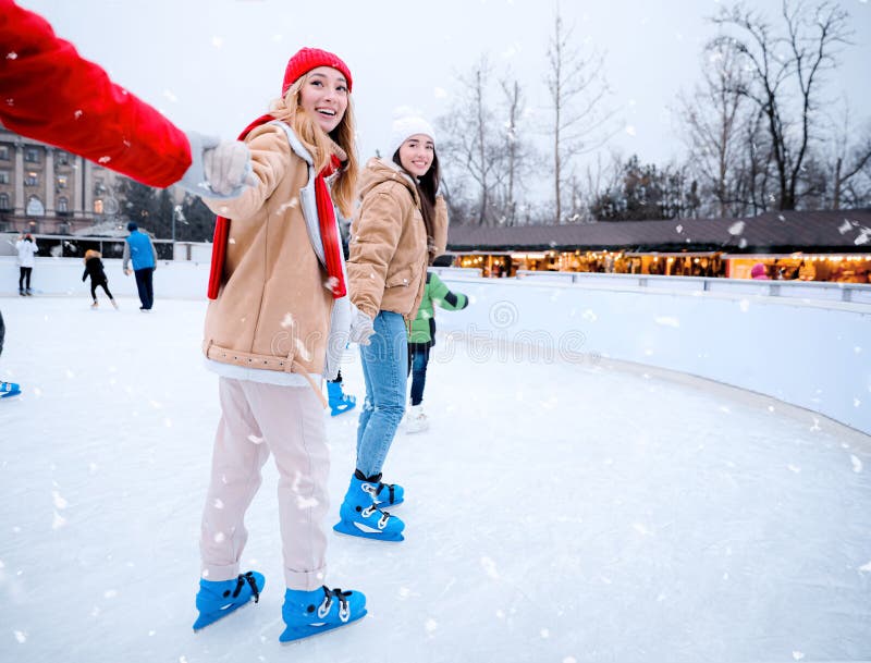 Group of Friends Skating at Outdoor Ice Rink Stock Image - Image of ...