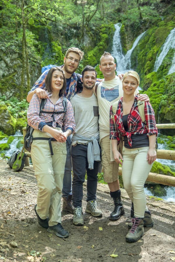 Group of Friends Standing in Front of a Beautiful Waterfall on a Sunny ...