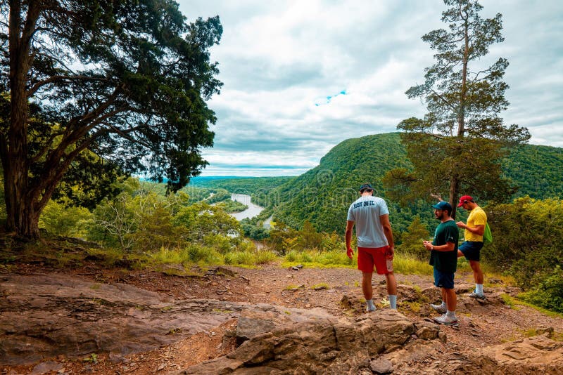 Group of Friends at the Summit of a Mountain, Taking in the View while ...