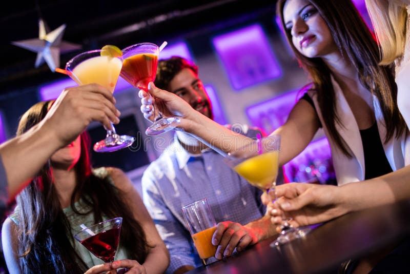 Group Of Friends Toasting Cocktail At Bar Counter Stock Image Image