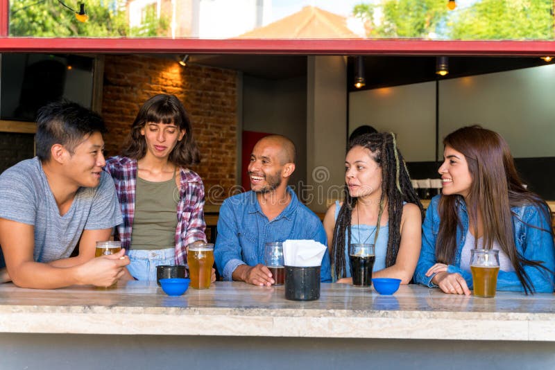 A Group of Friends Together in a Bar Stock Photo - Image of cheer ...