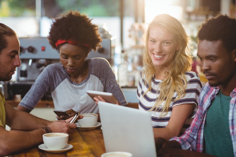 Group of Friends Using Mobile Phone and Laptop Stock Photo - Image of ...
