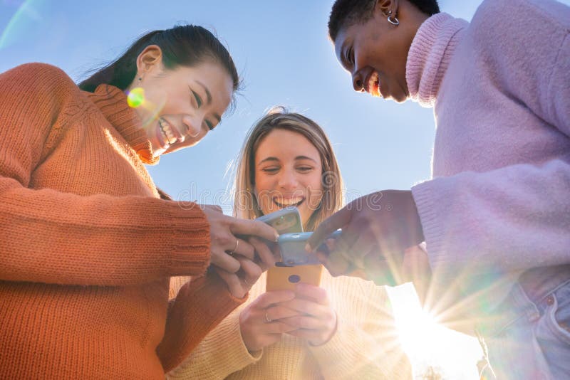 Group of Friends Using Mobile Phone Sharing Content on Social Media ...