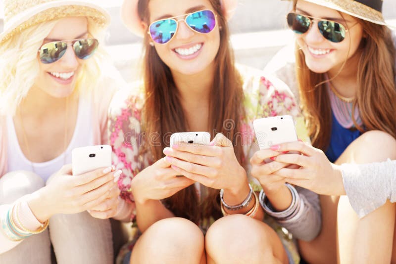 Group of Friends Using Smartphones in the City Stock Photo - Image of ...