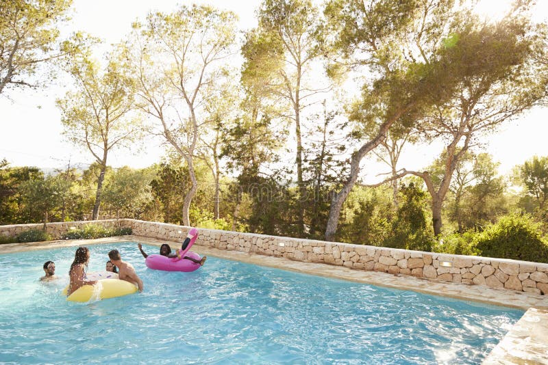 Group of Friends on Vacation Relaxing in Outdoor Pool Stock Image ...