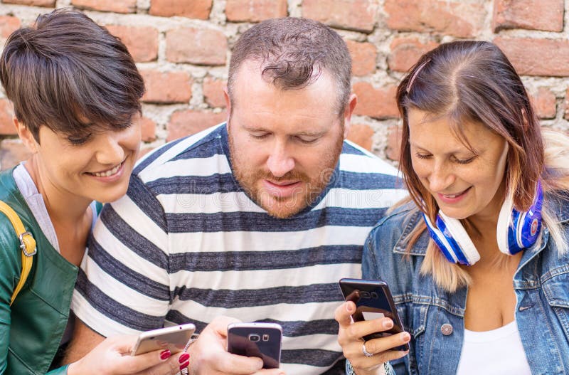Group of Friends Watching Smart Mobile Phones Stock Photo - Image of ...