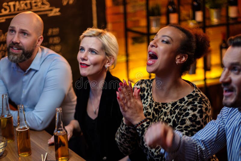 Group of Friends Watching Tv in a Cafe Behind Bar Counter Stock Image ...