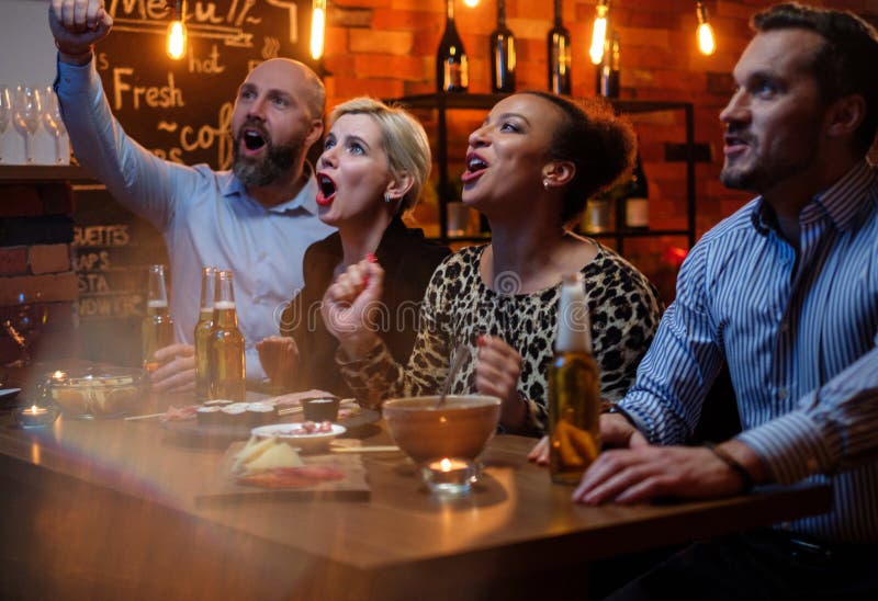 Group of Friends Watching Tv in a Cafe Behind Bar Counter Stock Image ...