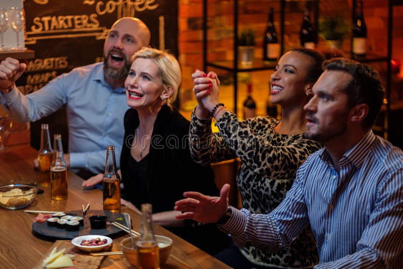 Group of Friends Watching Tv in a Cafe Behind Bar Counter Stock Image ...