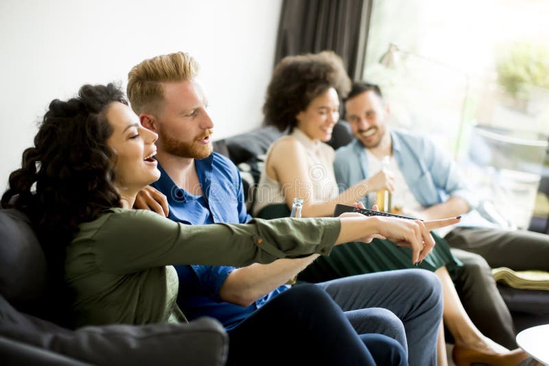 Group of Friends Watching TV, Drinking Cider and Having Fun Stock Photo ...