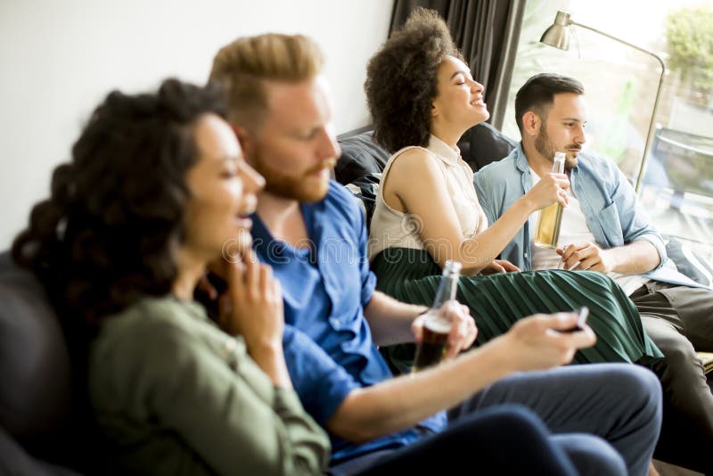Group of Friends Watching TV, Drinking Cider and Having Fun Stock Photo ...