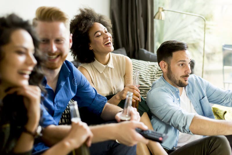 Group of Friends Watching TV, Drinking Cider and Having Fun Stock Image ...