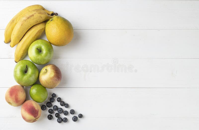 Group of Fruits Over White Wooden Table with Copy Space Stock Photo ...