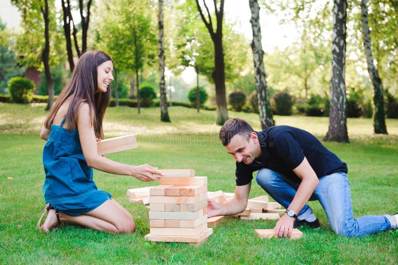 Group Game of Physical Skill with Big Blocks on the Green Grass. Stock ...