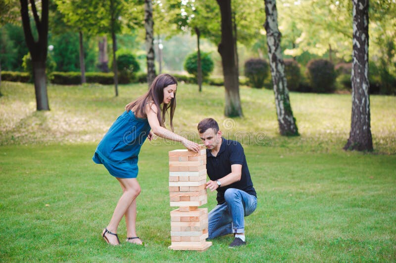 Group Game of Physical Skill with Big Blocks on the Green Grass. Stock ...