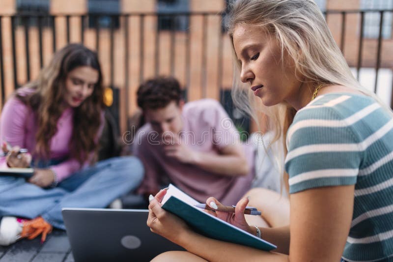 Group of Generation Z Students Studying Together Outdoors after School ...