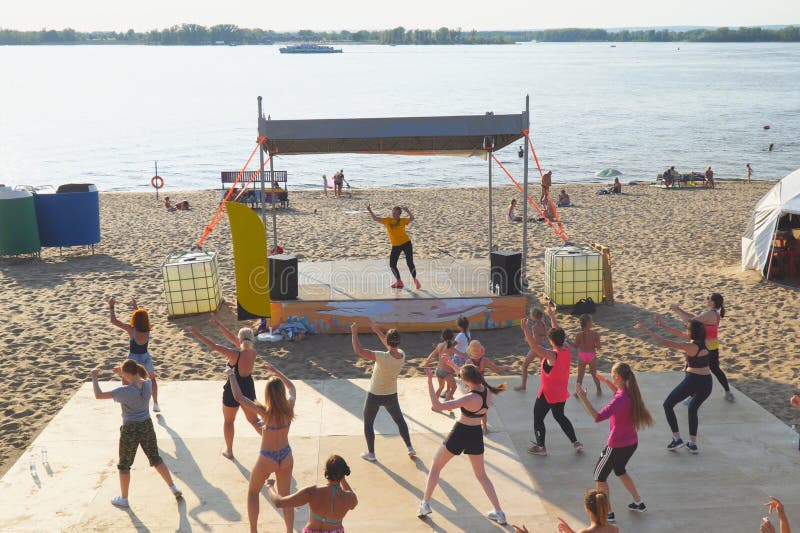Group of Girls are Doing Aerobics or Dancing on the Beach with a Dance ...
